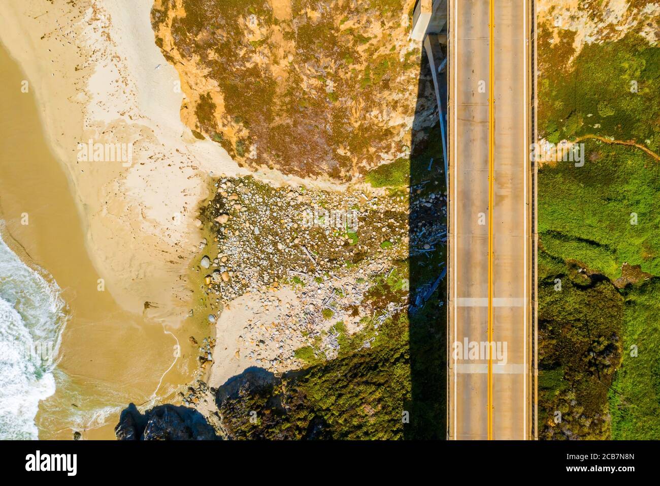 Aerial overhead shot of a road above the seashore at daytime Stock ...