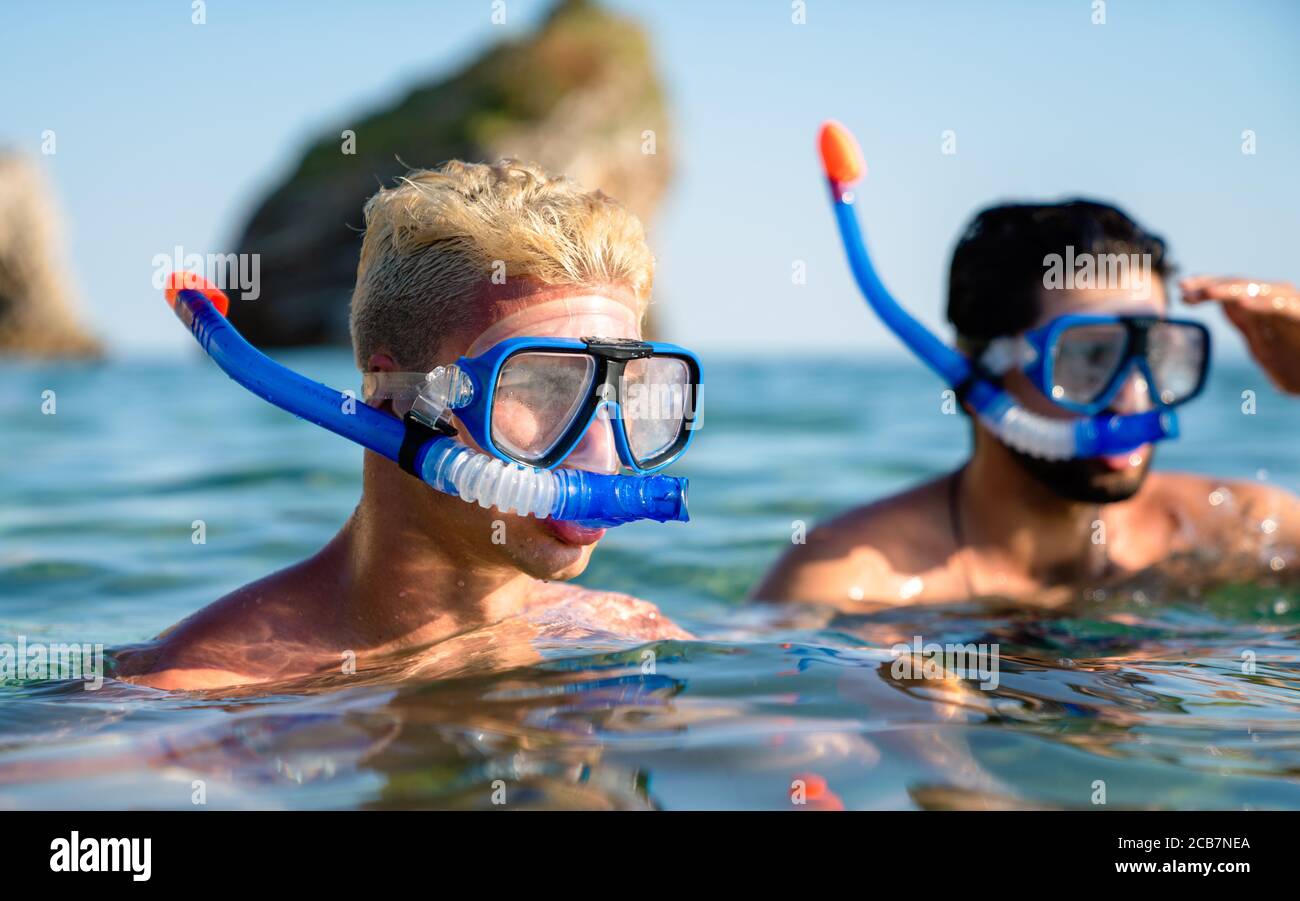 Group of happy fit friends go scuba diving together on summer vacation ...