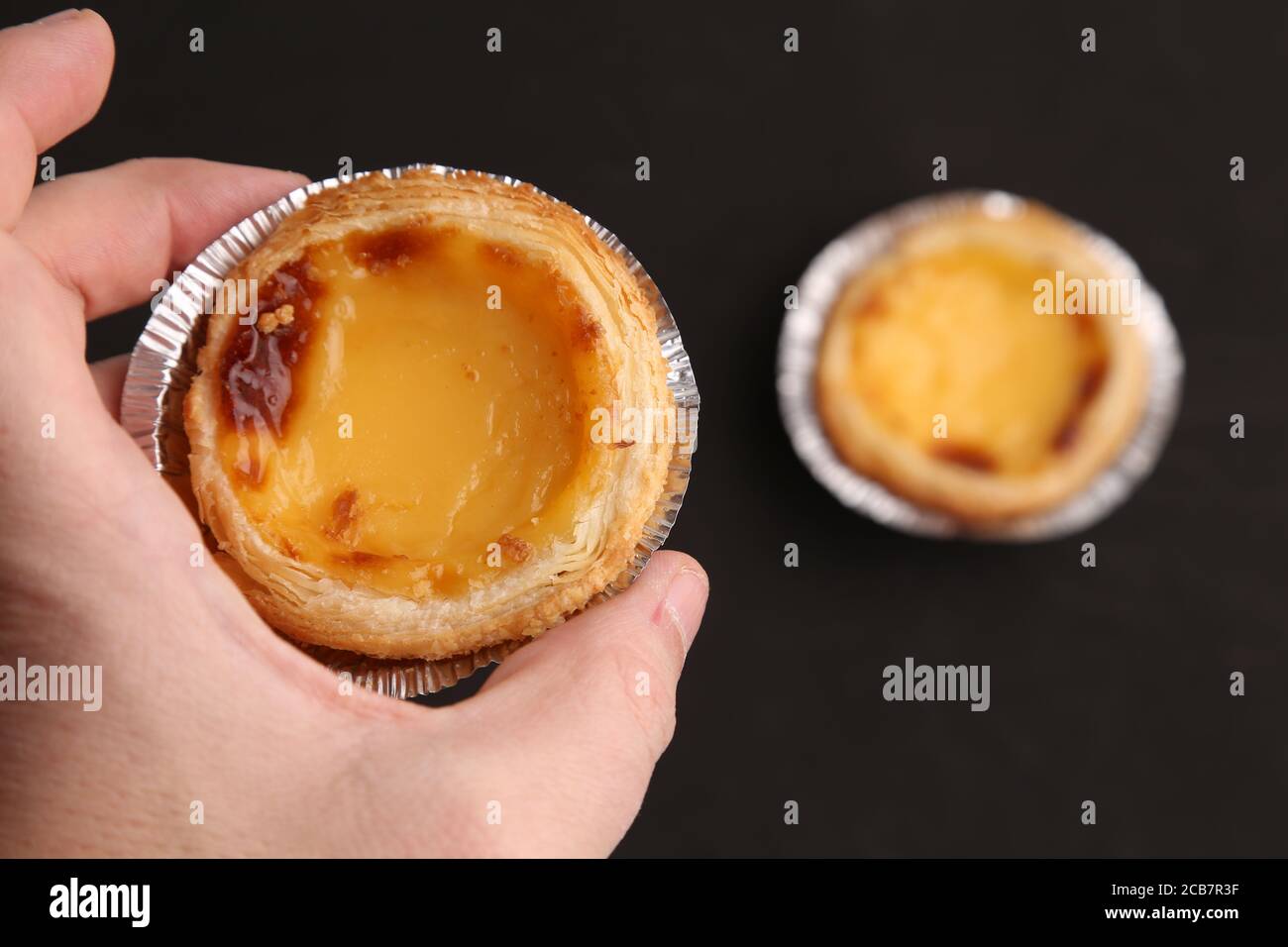 Closeup shot of delicious small cream cake in color background Stock ...