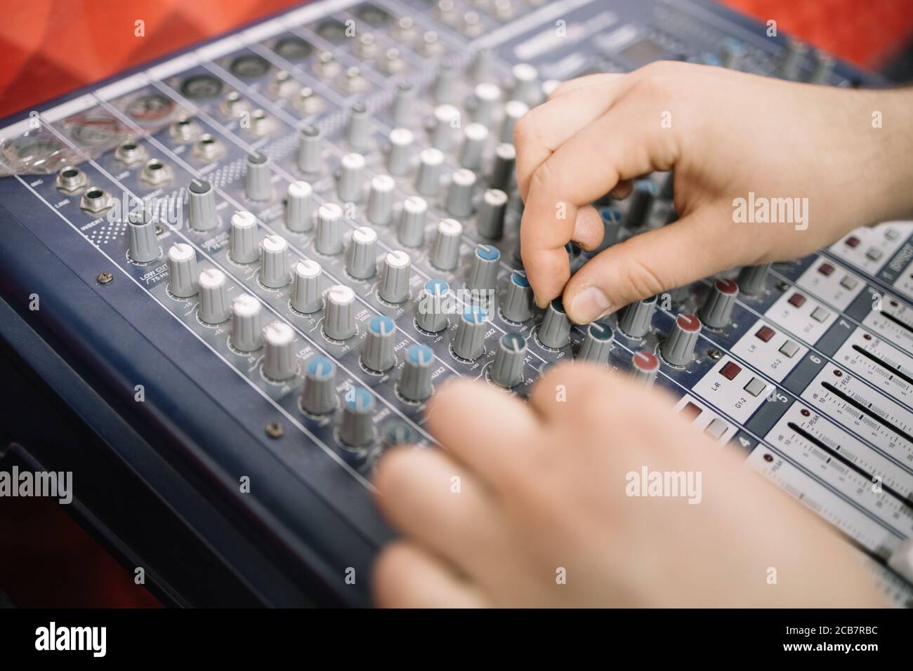 Male hands adjusting sound on music controller Stock Photo - Alamy