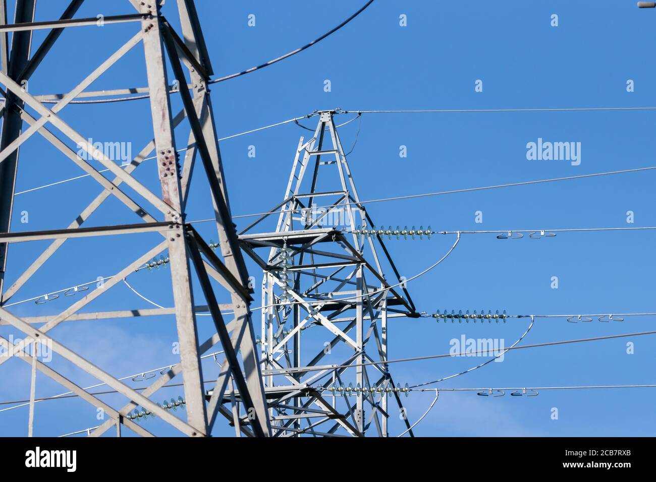Grey steel hydro electric towers against blue sky Stock Photo - Alamy
