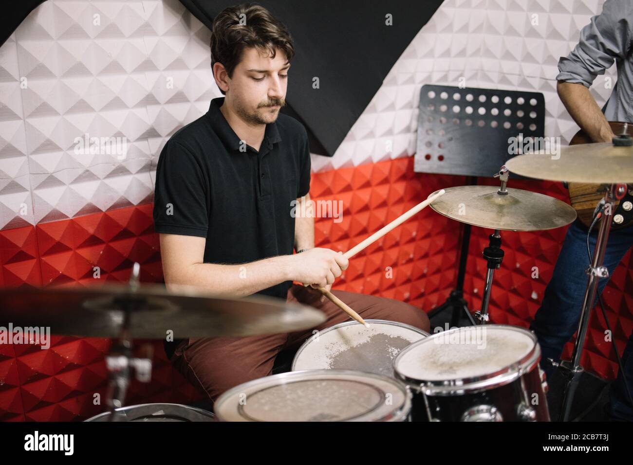 Portrait of male drummer playing on drum set in studio Stock Photo - Alamy