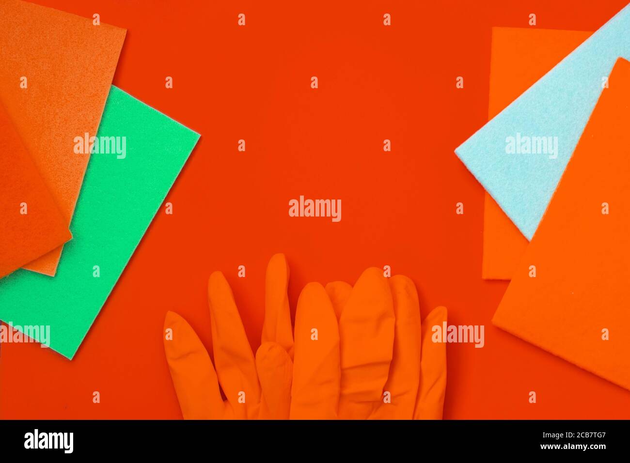 Orange and red, green rags, red gloves on red background. Cleaning ...