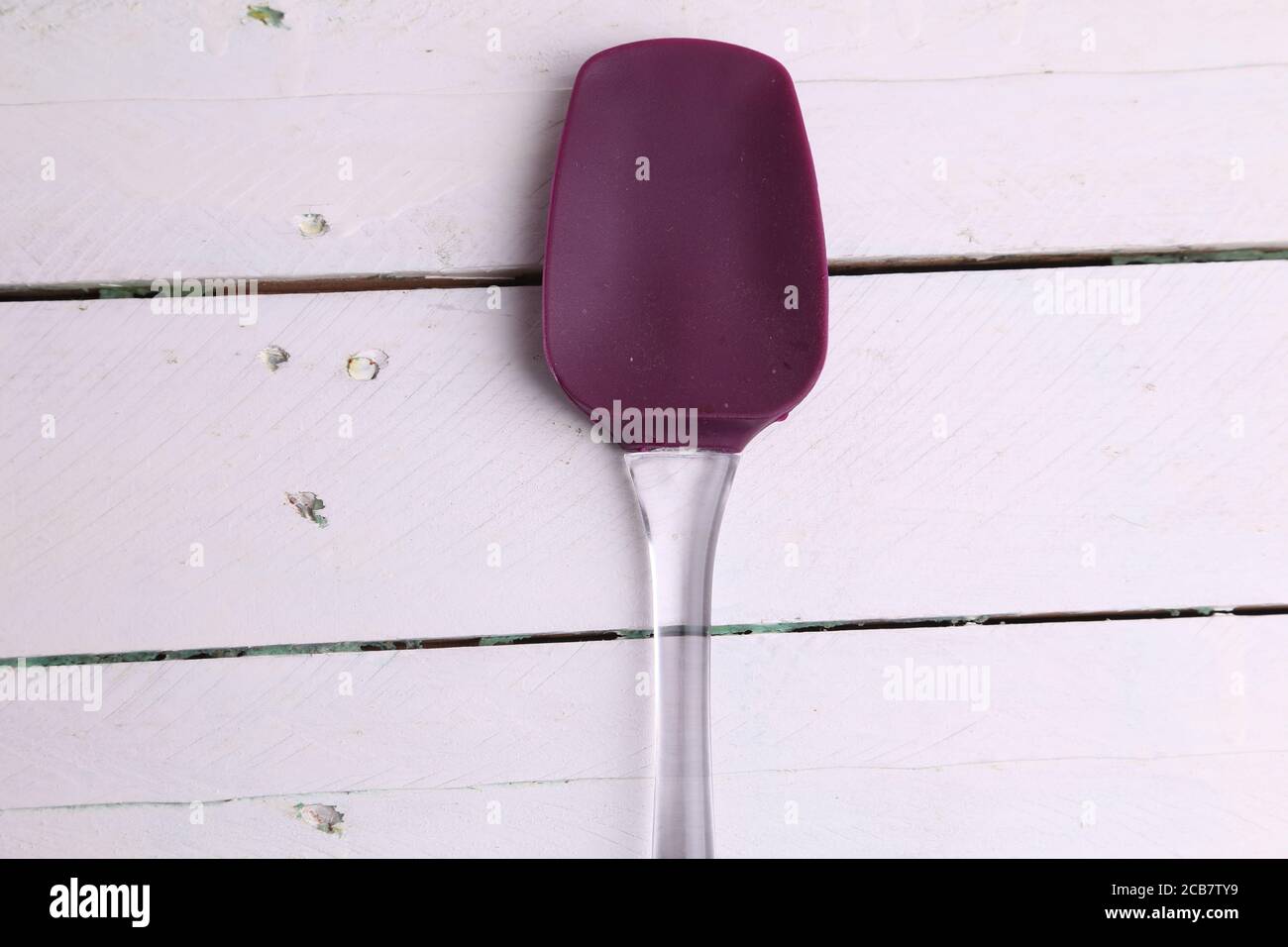 Top view of a purple flexible spatula on a white wooden surface Stock ...