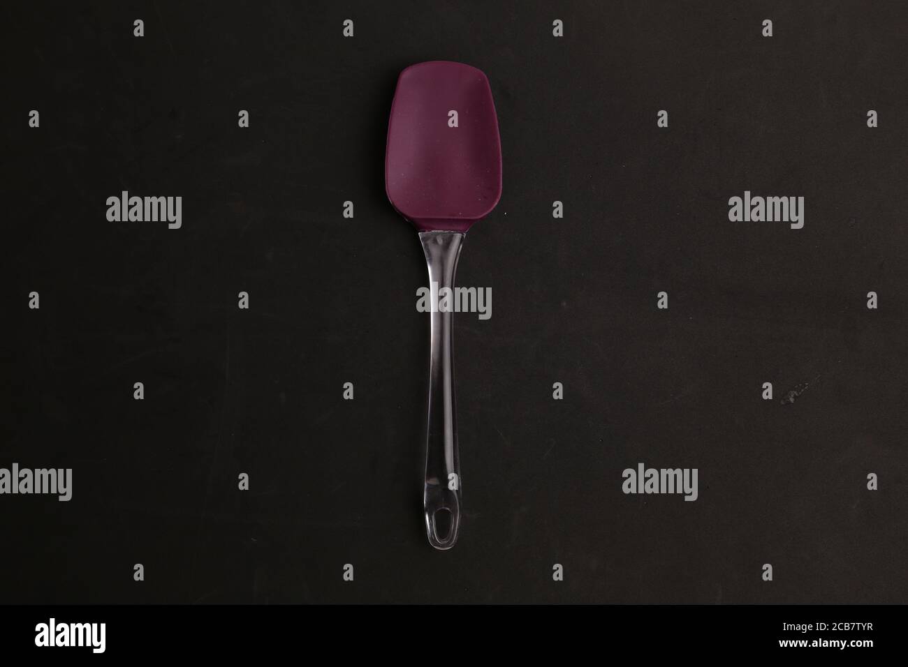 Top view of a kitchen silicone spatula isolated on a black background ...
