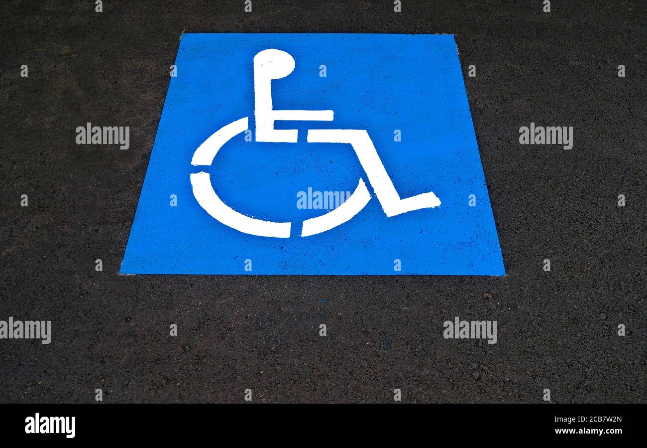 International Symbol of Access painted in blue and white on a black ...
