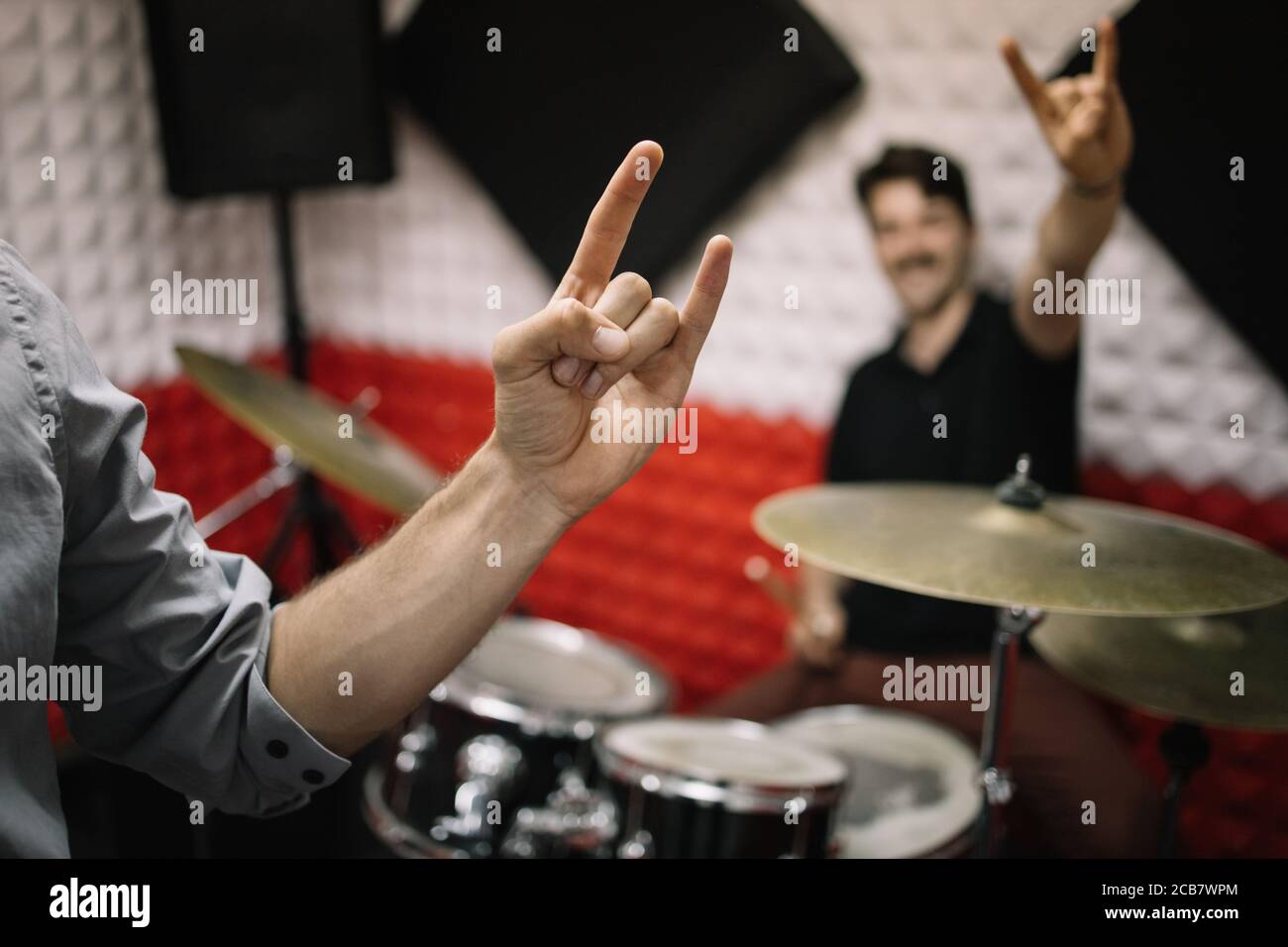Male hands showing rock and roll hand sign Stock Photo - Alamy