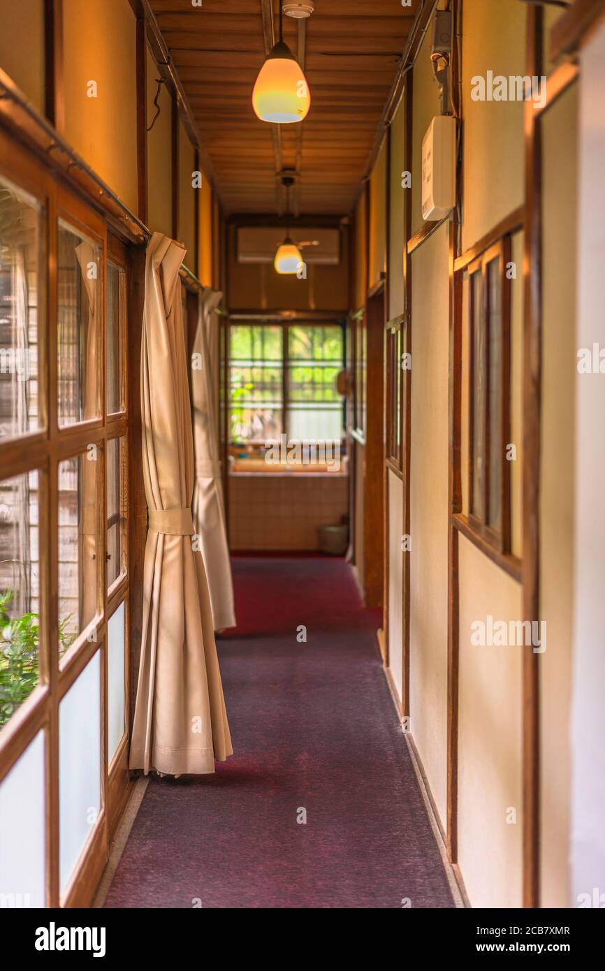 Narrow hallway of a traditional Japanese inn ryokan with the luminosity ...