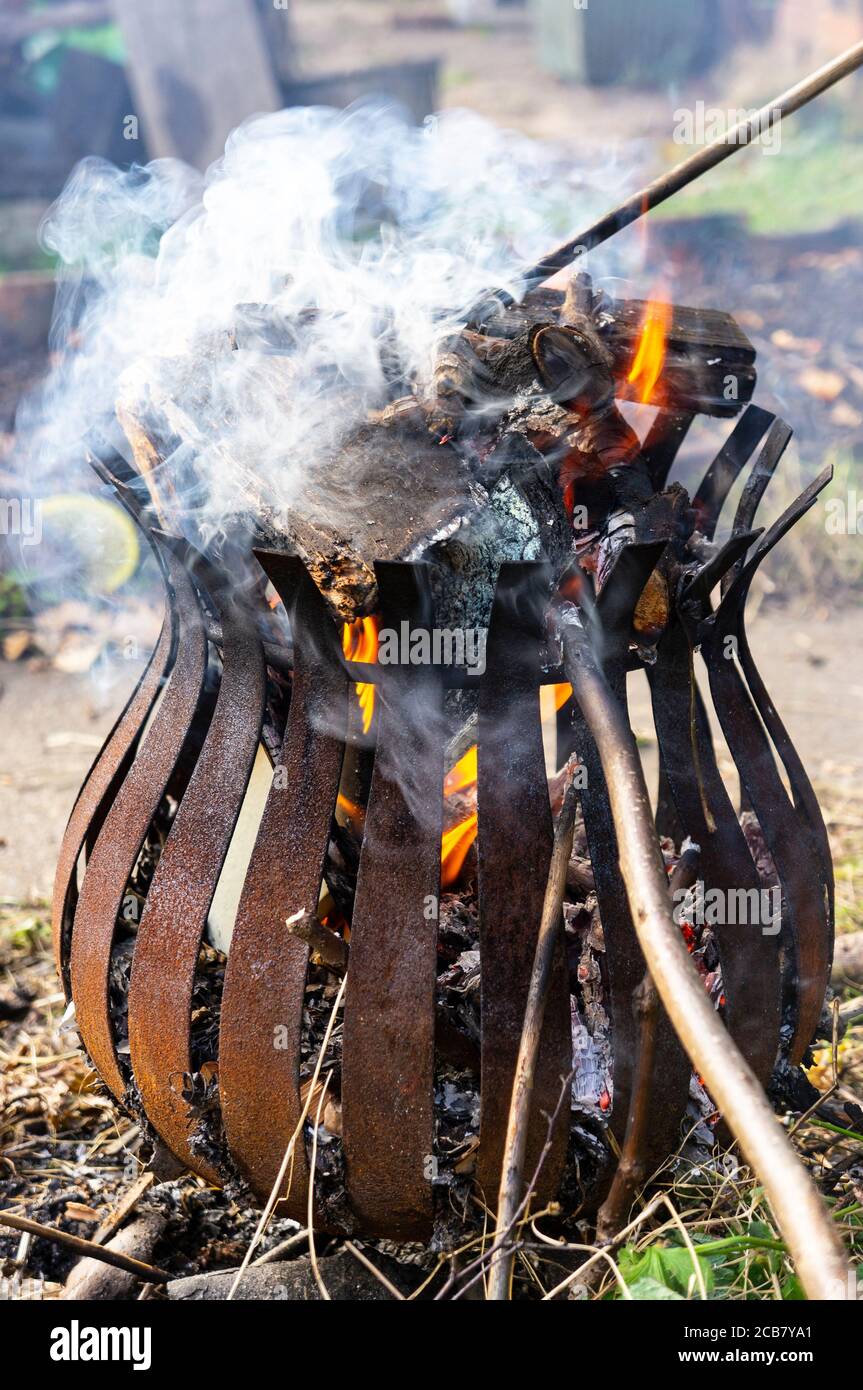 Small fire in a metal brazier Stock Photo - Alamy