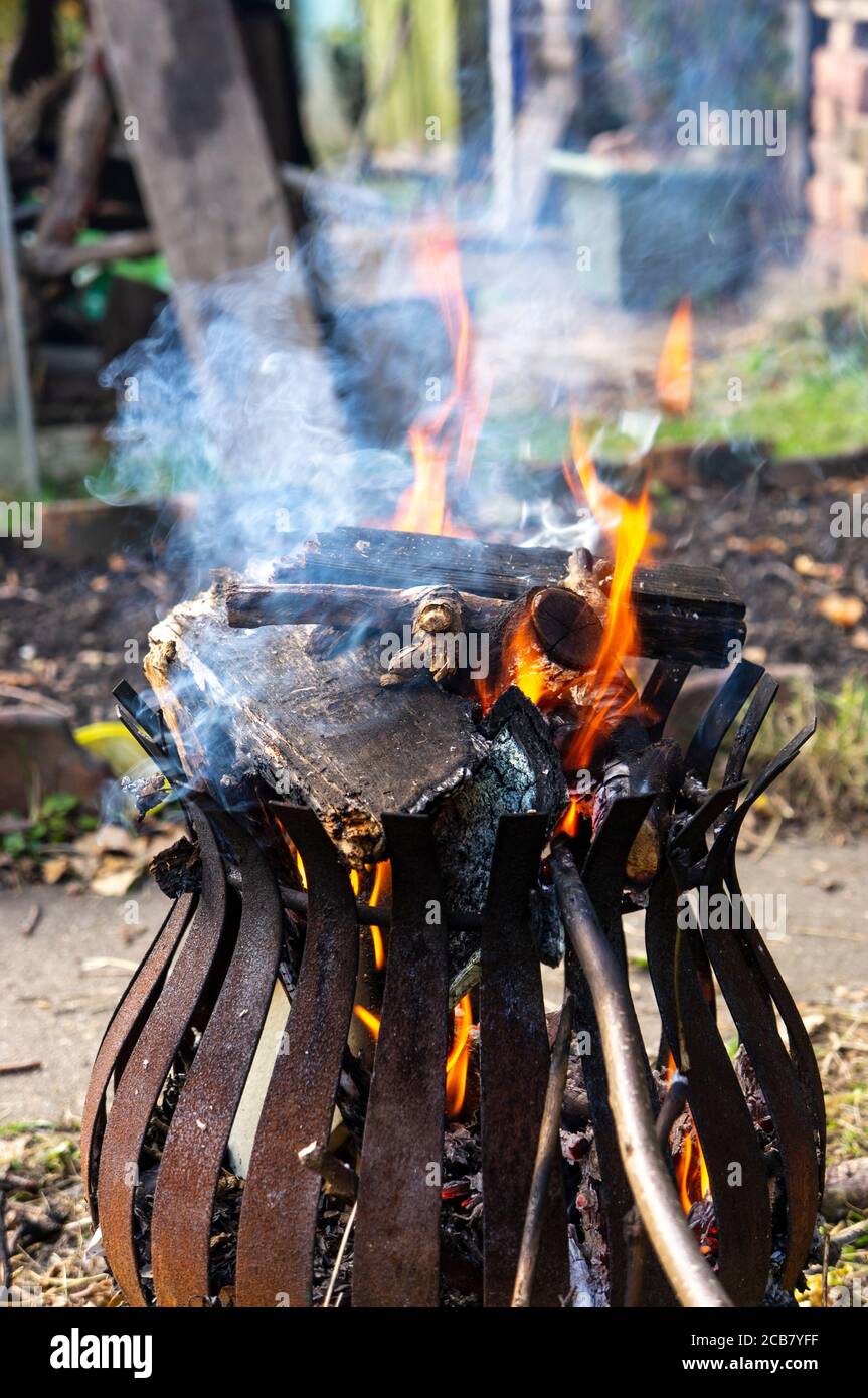 Small fire in a metal brazier Stock Photo - Alamy