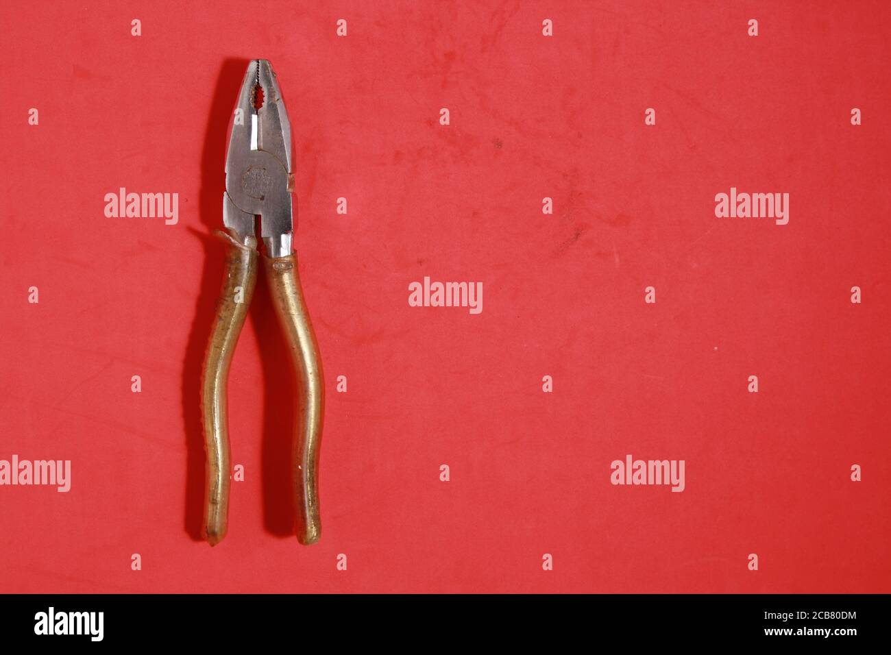 Top view of old pliers isolated n a red background Stock Photo - Alamy