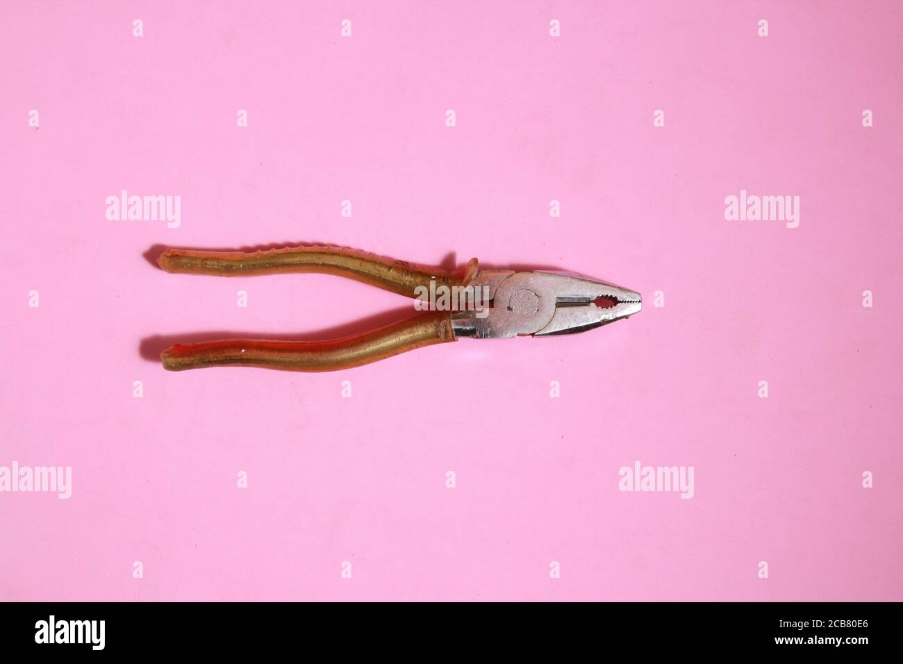 Top view of the old rusty pliers isolated on a pink background Stock ...