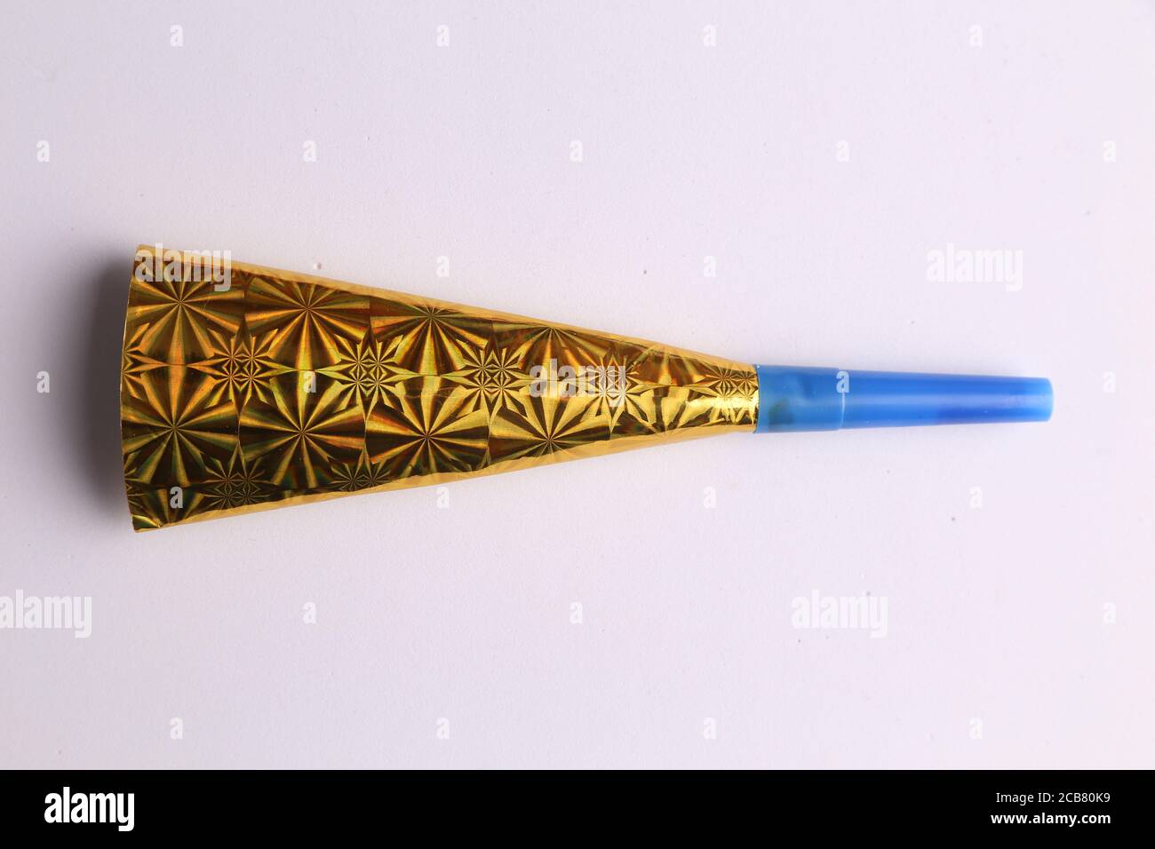 Closeup of a gold party cardboard trumpet on white background Stock ...