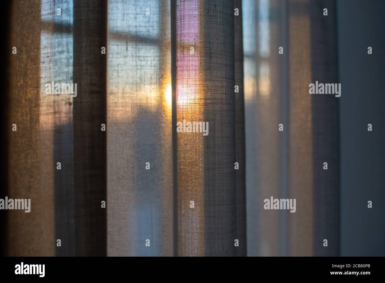 Sunset through the curtain of a window Stock Photo - Alamy