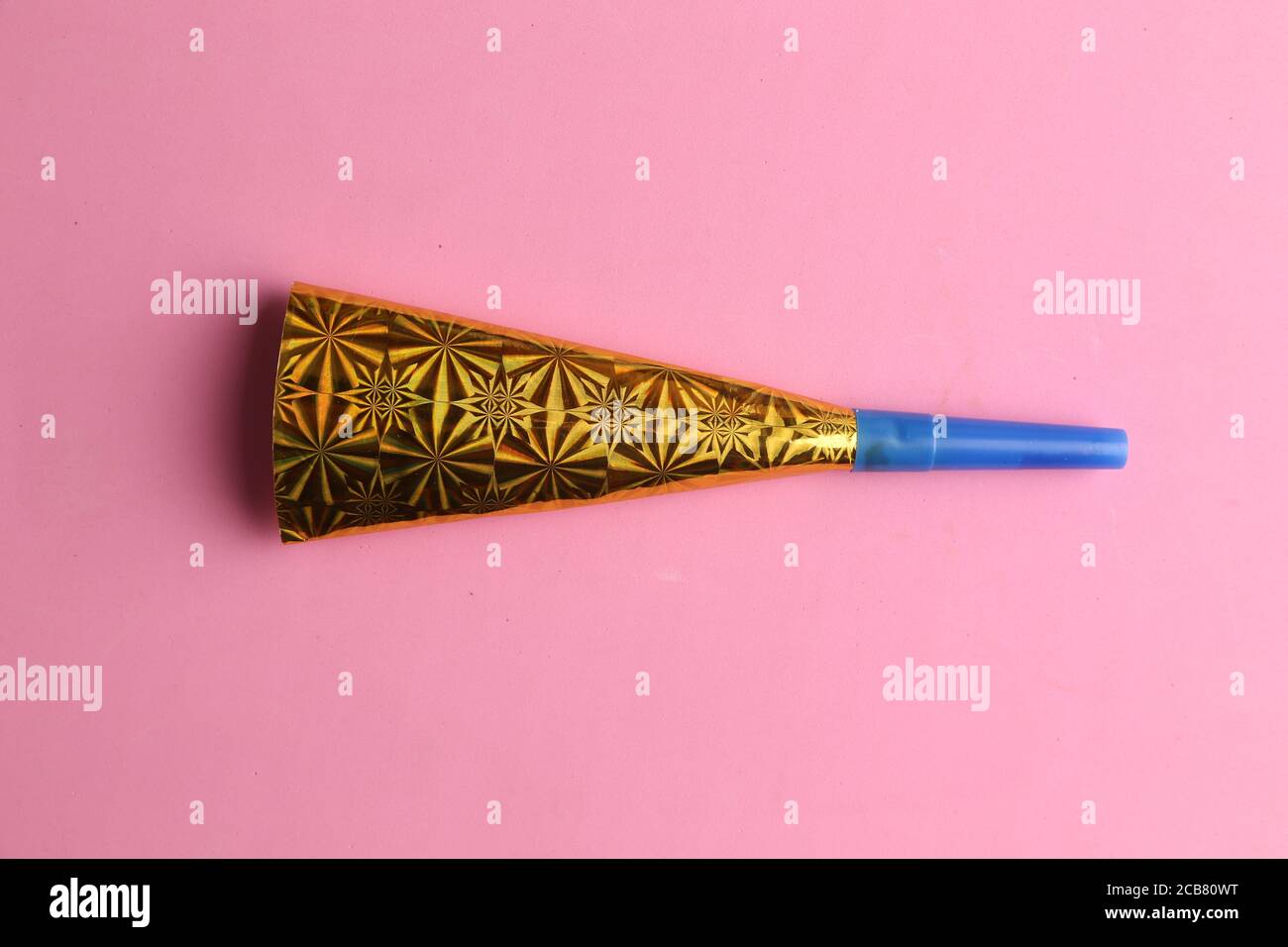 Party cardboard trumpet on colorful background Stock Photo - Alamy