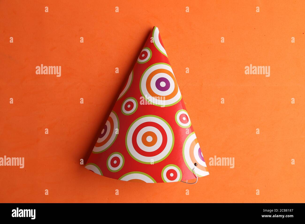 Party cardboard cone-shaped hat on colorful background Stock Photo - Alamy