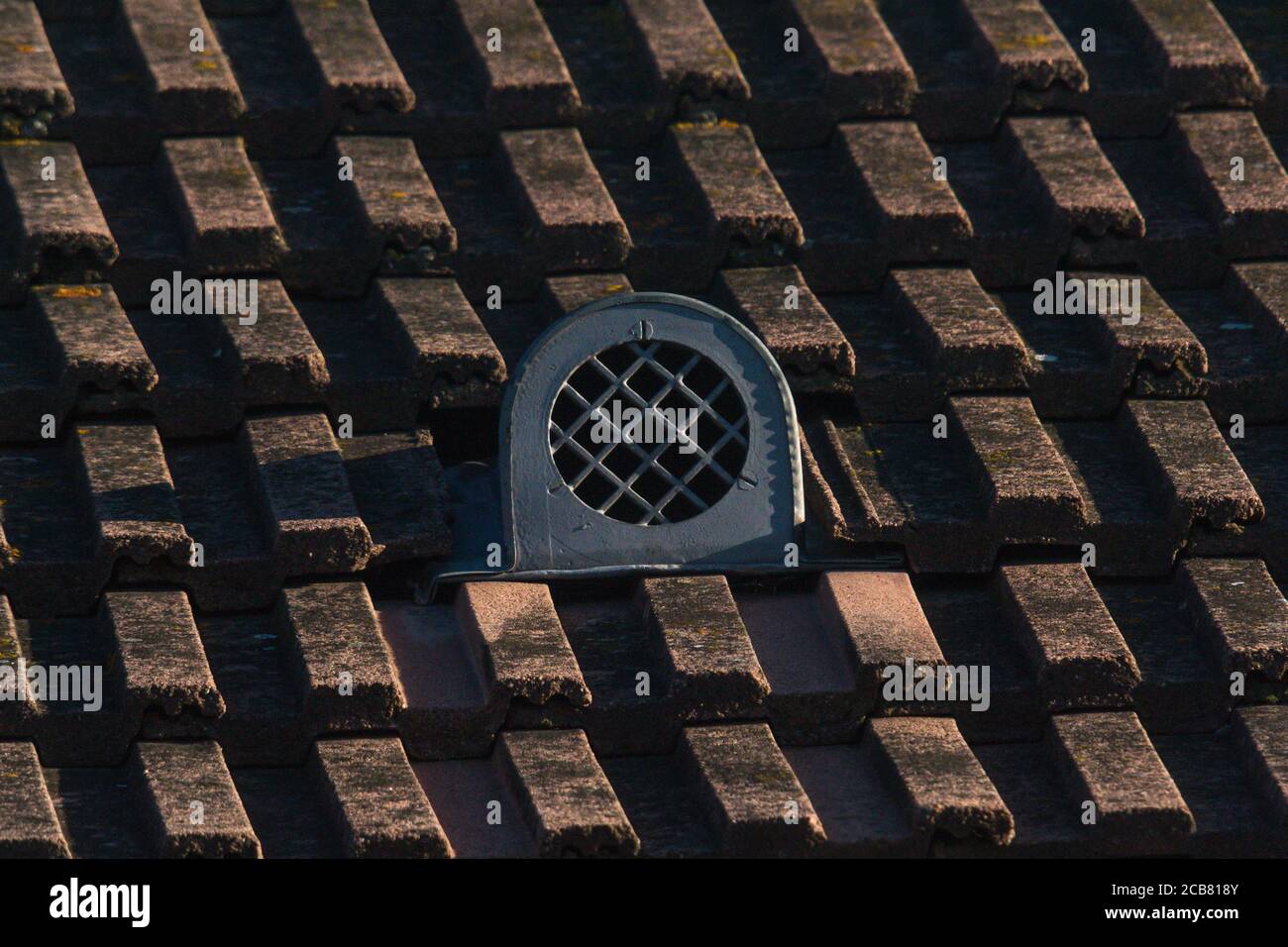 Vintage tiled roof with air vent of an old style house Stock Photo - Alamy