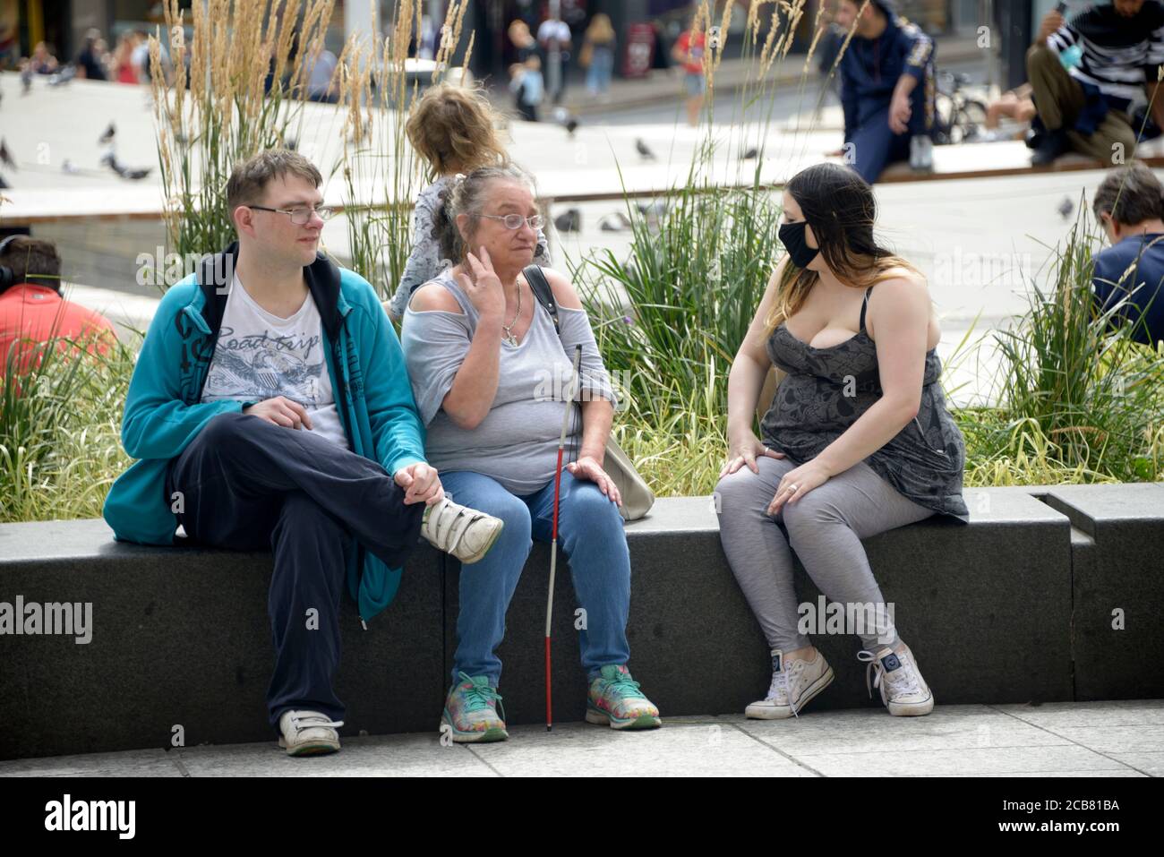 Fat family sitting in the Square, in Nottingham Stock Photo - Alamy