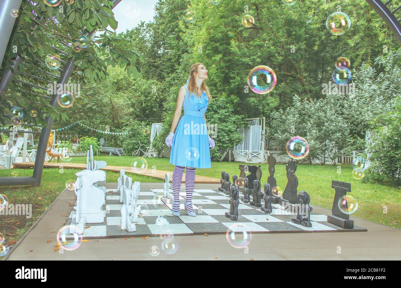 Alice cosplay closeup with milticolored bubbles in wonderland Stock ...