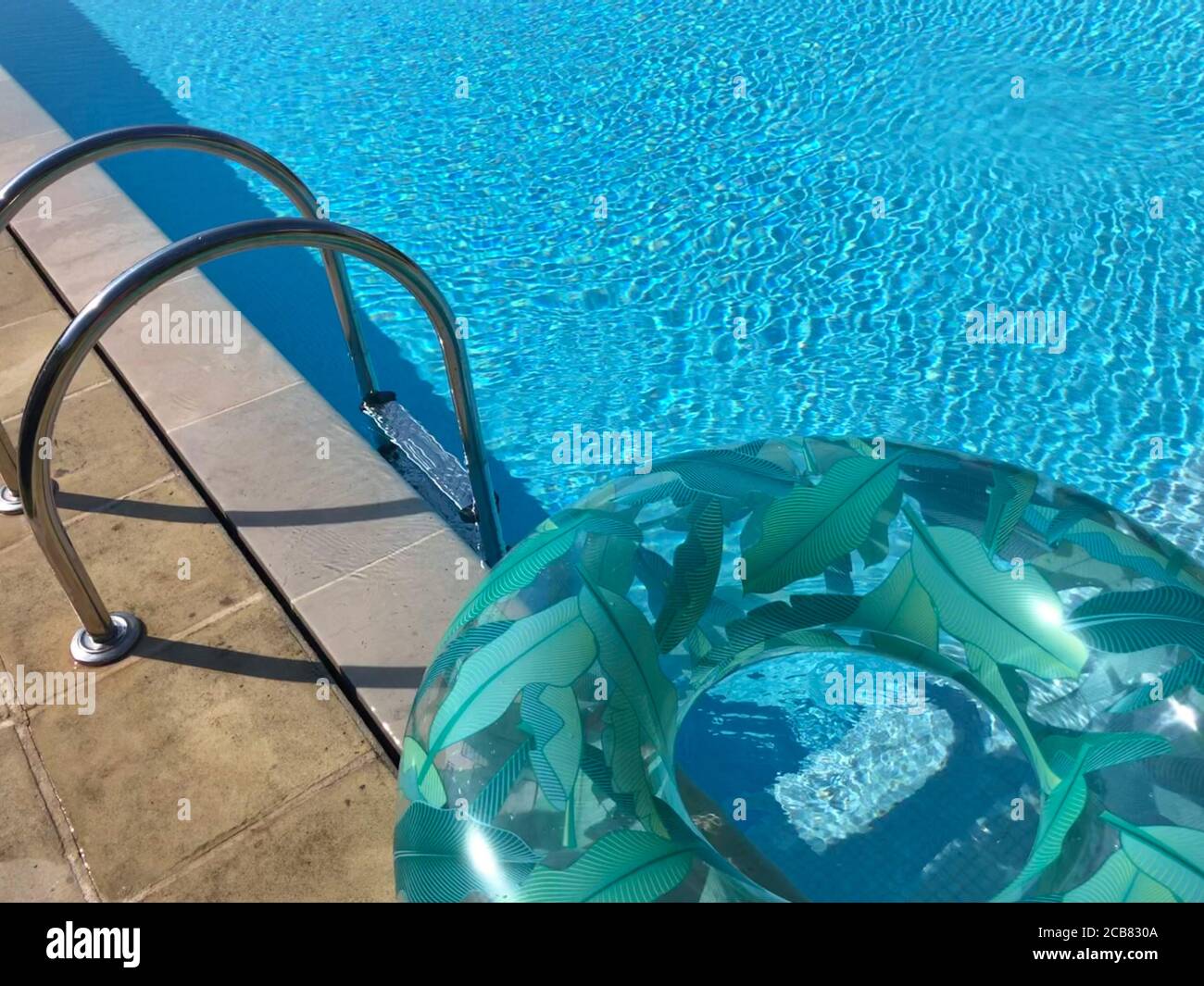 Inflatable rubber ring at the edge of a swimming pool Stock Photo - Alamy