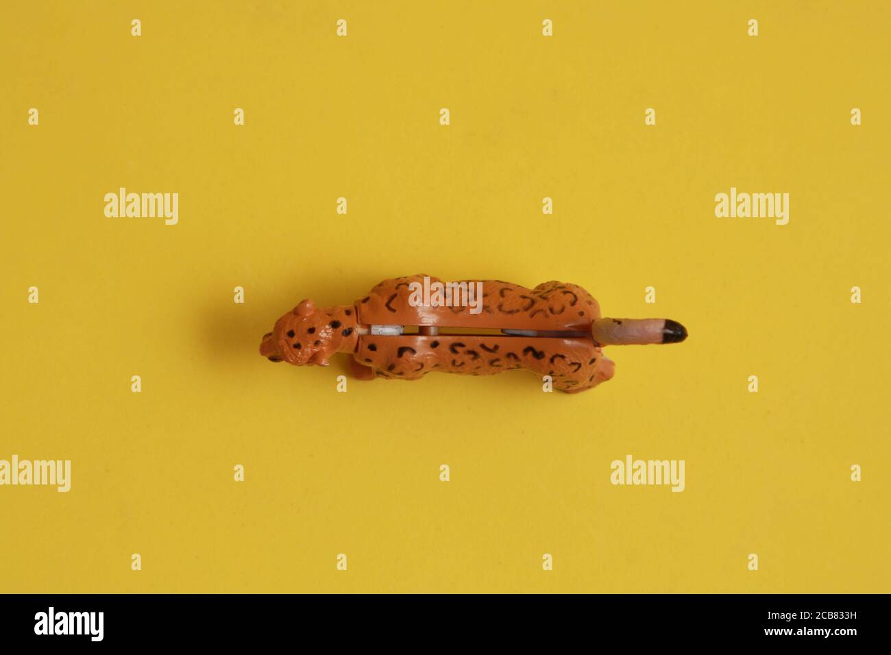 Small plastic leopard toy isolated on a yellow background Stock Photo ...