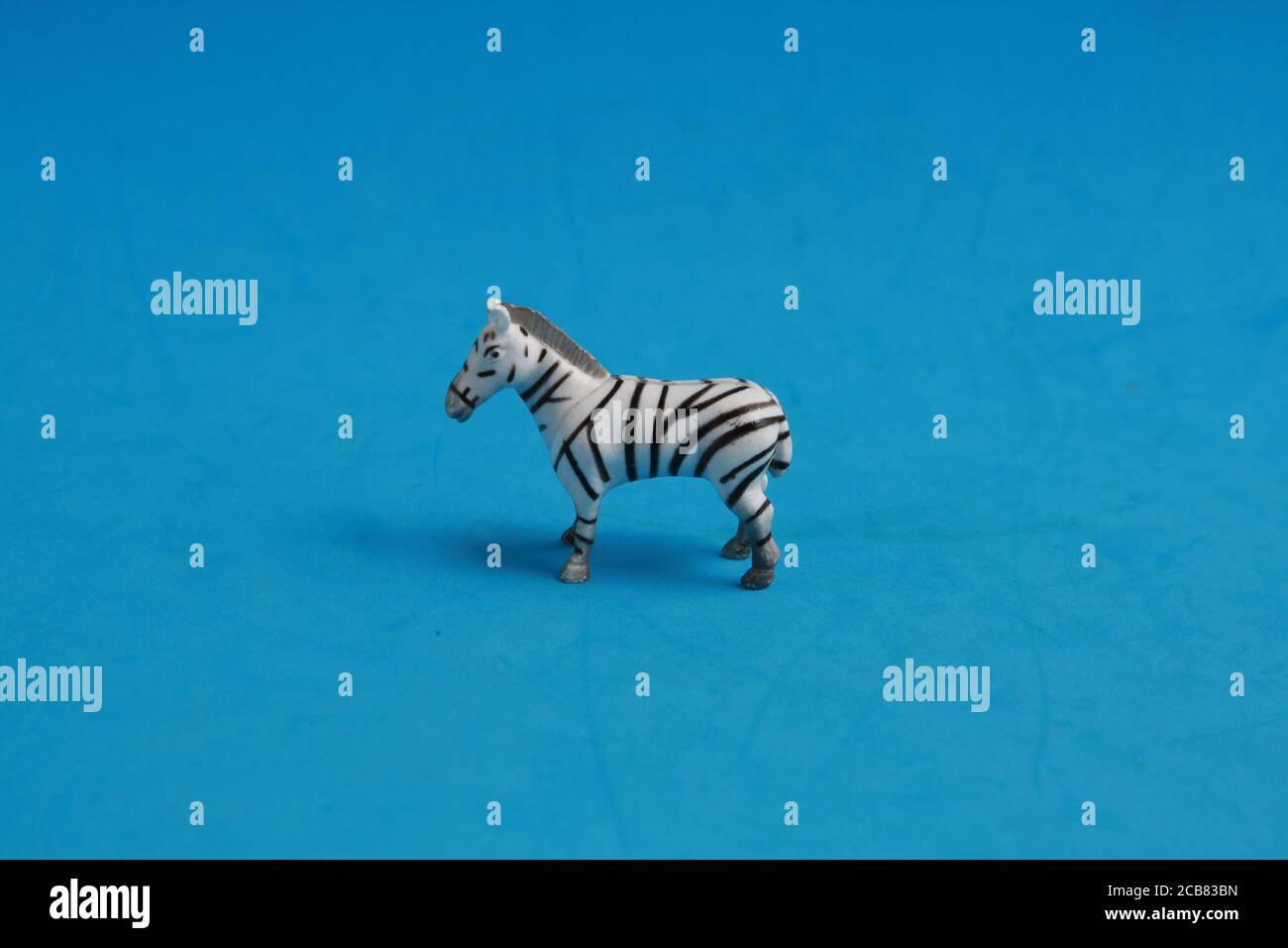 Plastic toy with zebra shape in color background Stock Photo - Alamy
