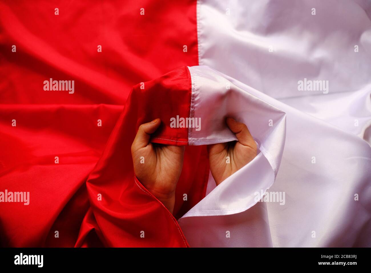 Hands holding an Indonesian flag, Indonesia Stock Photo - Alamy