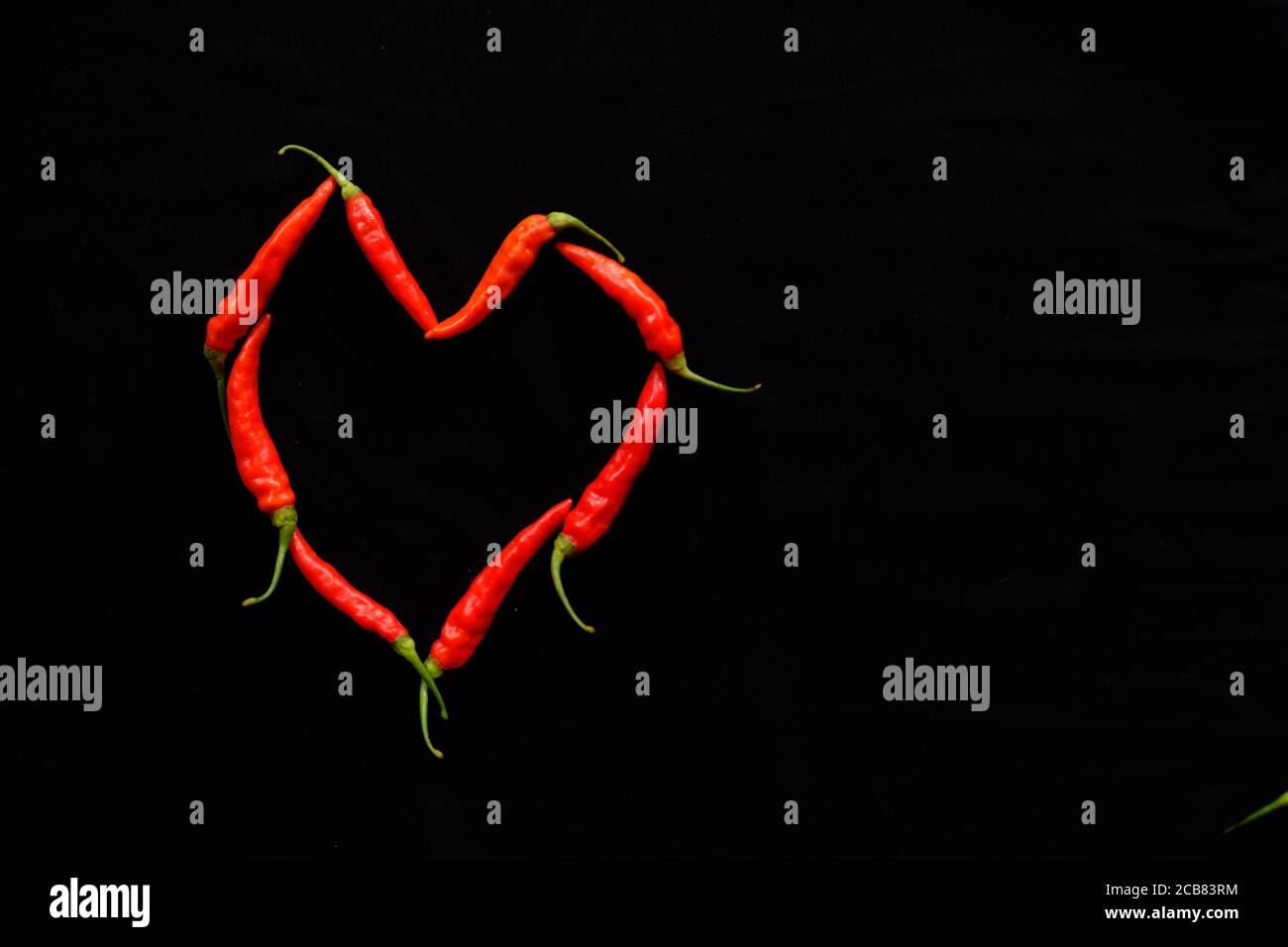 Red Chilli peppers in a heart shape Stock Photo - Alamy