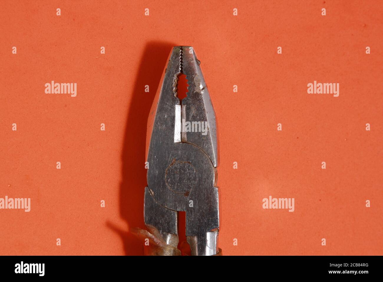 Old pliers in color background Stock Photo - Alamy