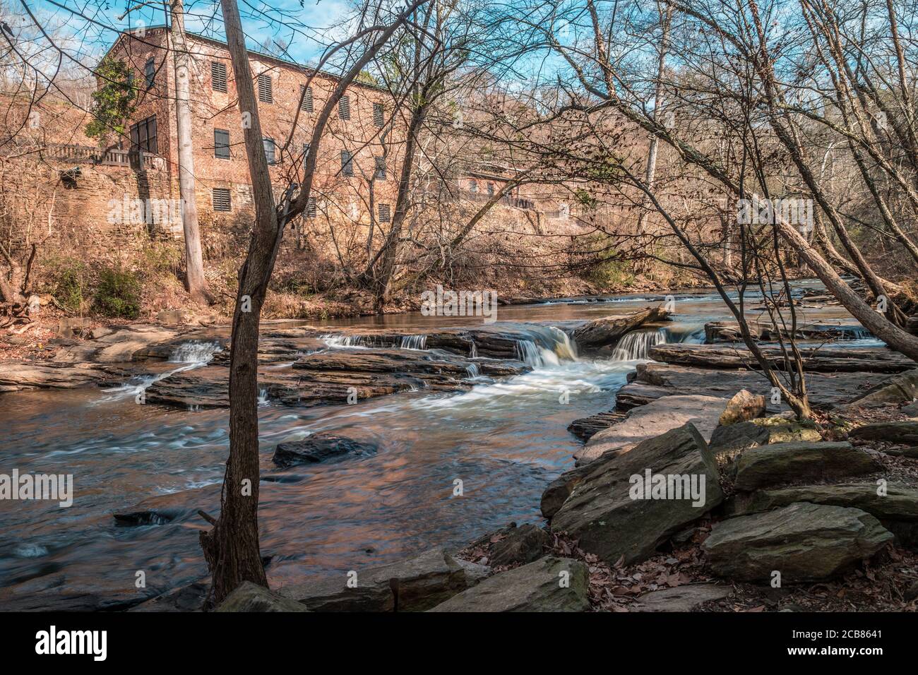 Big creek flowing with small waterfalls downstream alongside the old ...