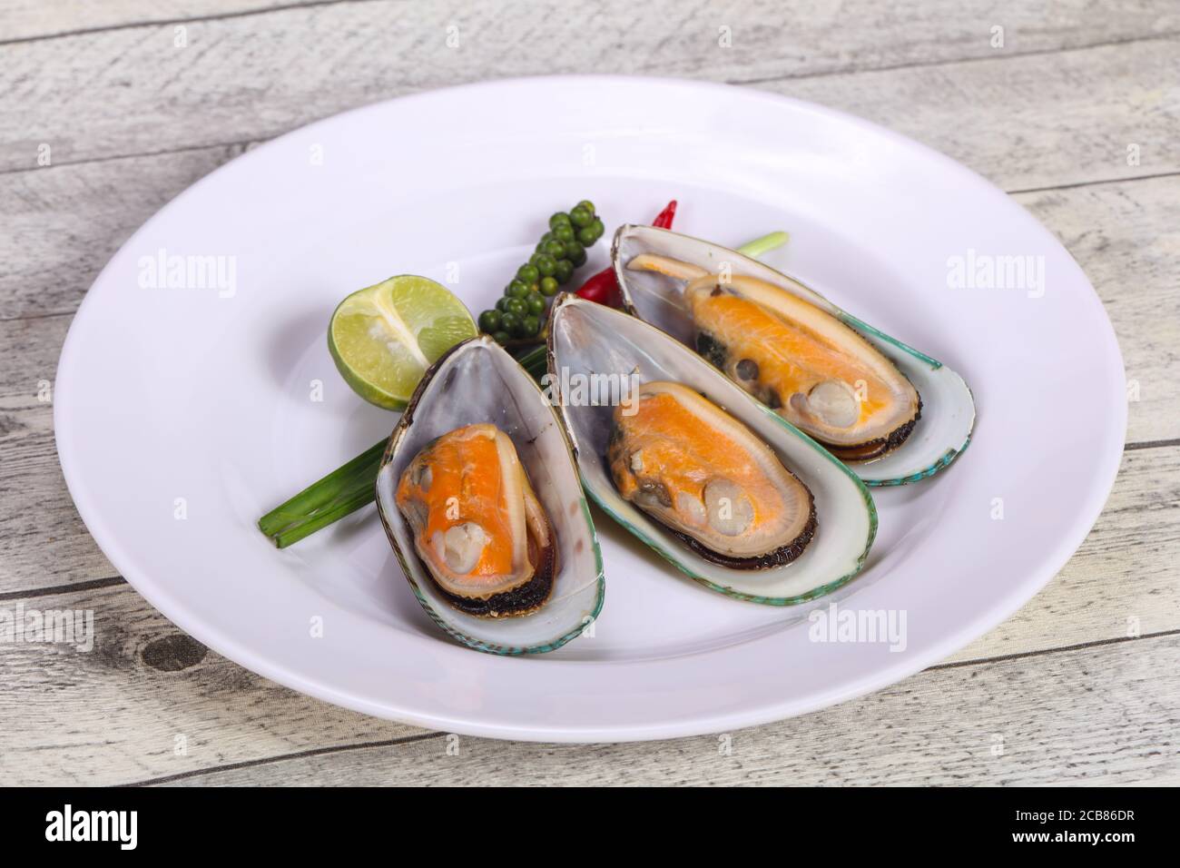 Half mussels with lime and green pepper Stock Photo - Alamy