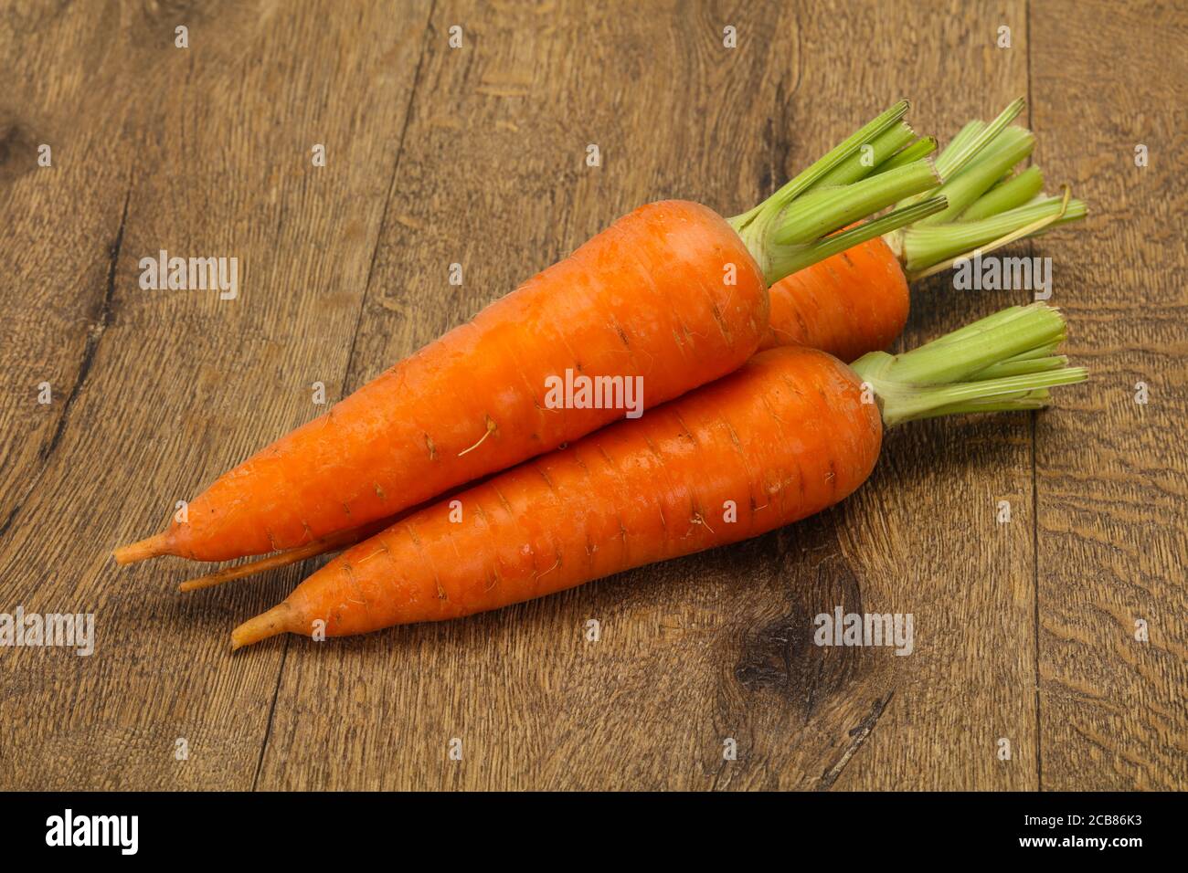 Three Young fresh ripe carrots Stock Photo - Alamy