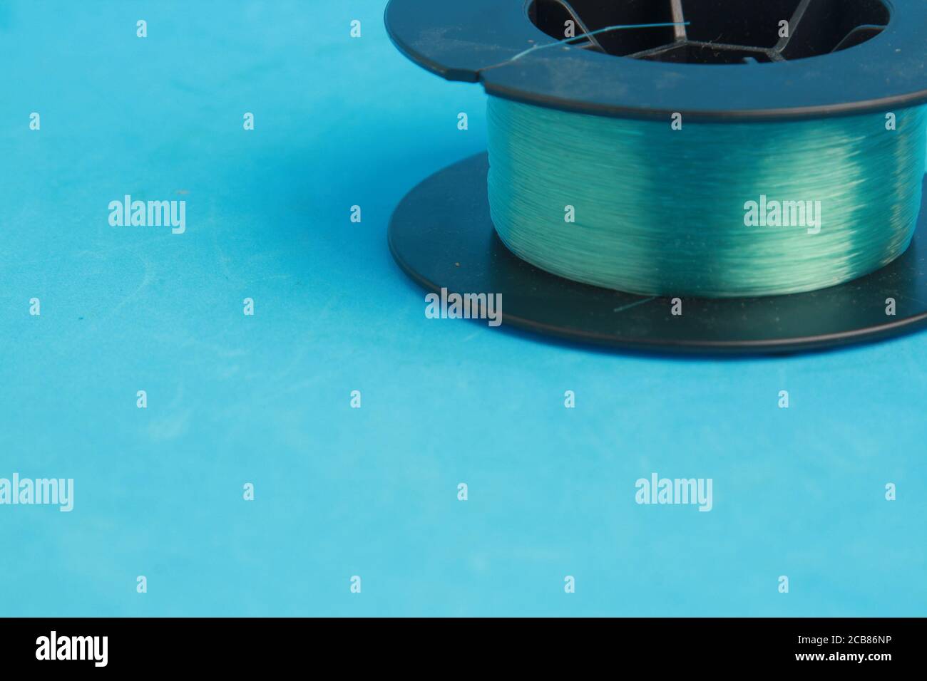 Closeup shot of a roll of nylon fishing line on a blue background Stock ...