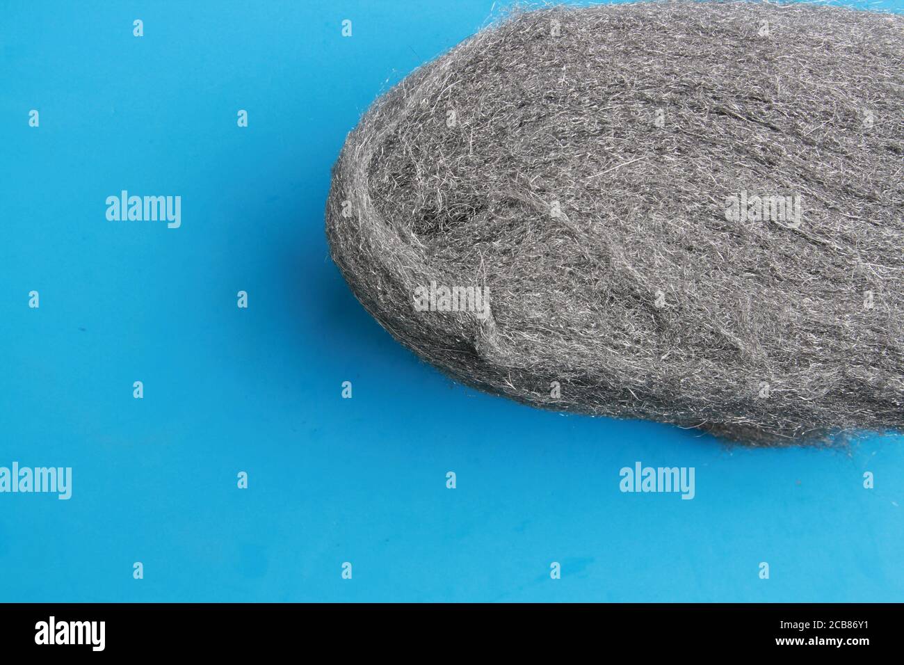 Steel wool roll in color background Stock Photo - Alamy