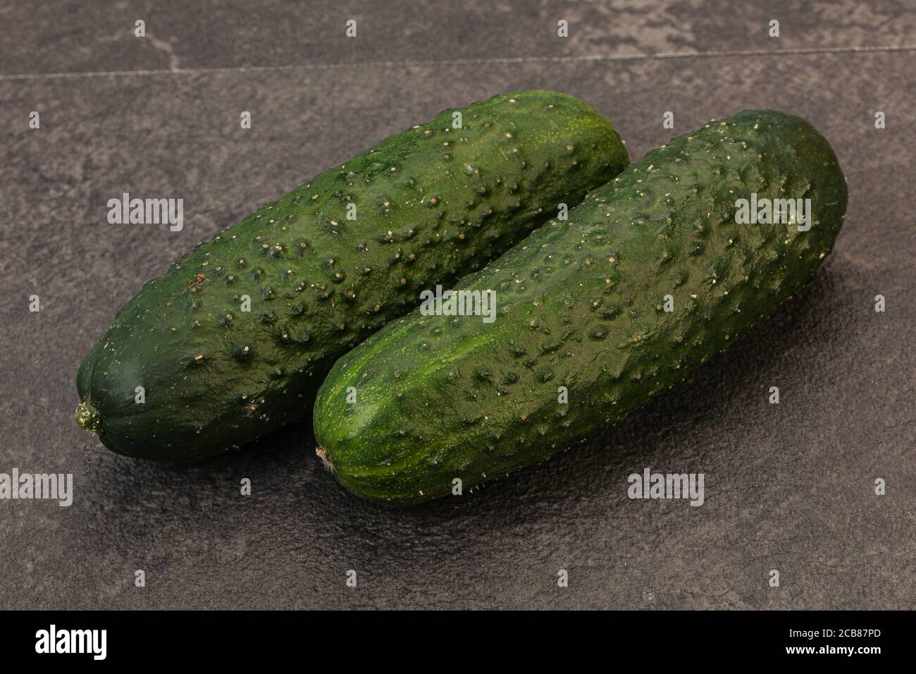 Green fresh two cucumbers over background Stock Photo - Alamy