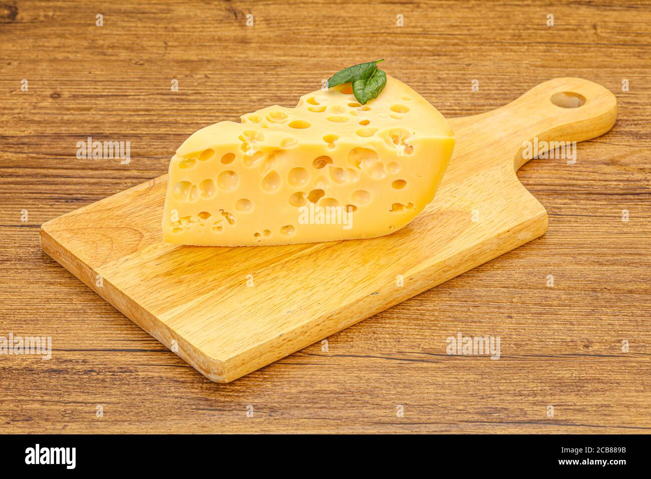 Maasdam cheese - dairy yellow triangle with holes Stock Photo - Alamy