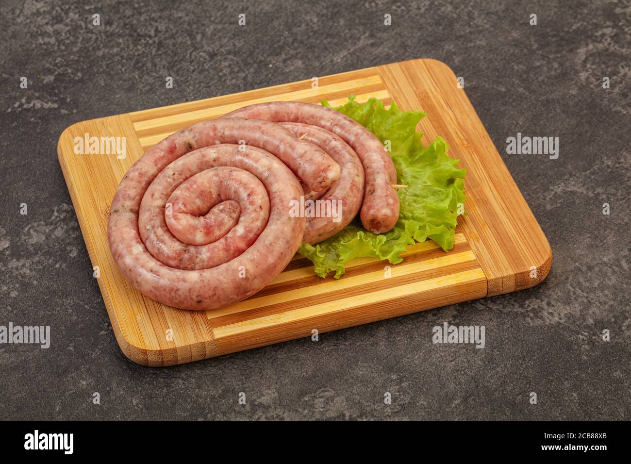 Raw pork sausage ring for grill Stock Photo - Alamy