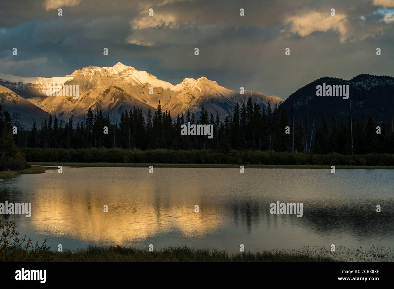 Evening skies over Cascade Range reflected in Vermilion Lakes, Banff ...