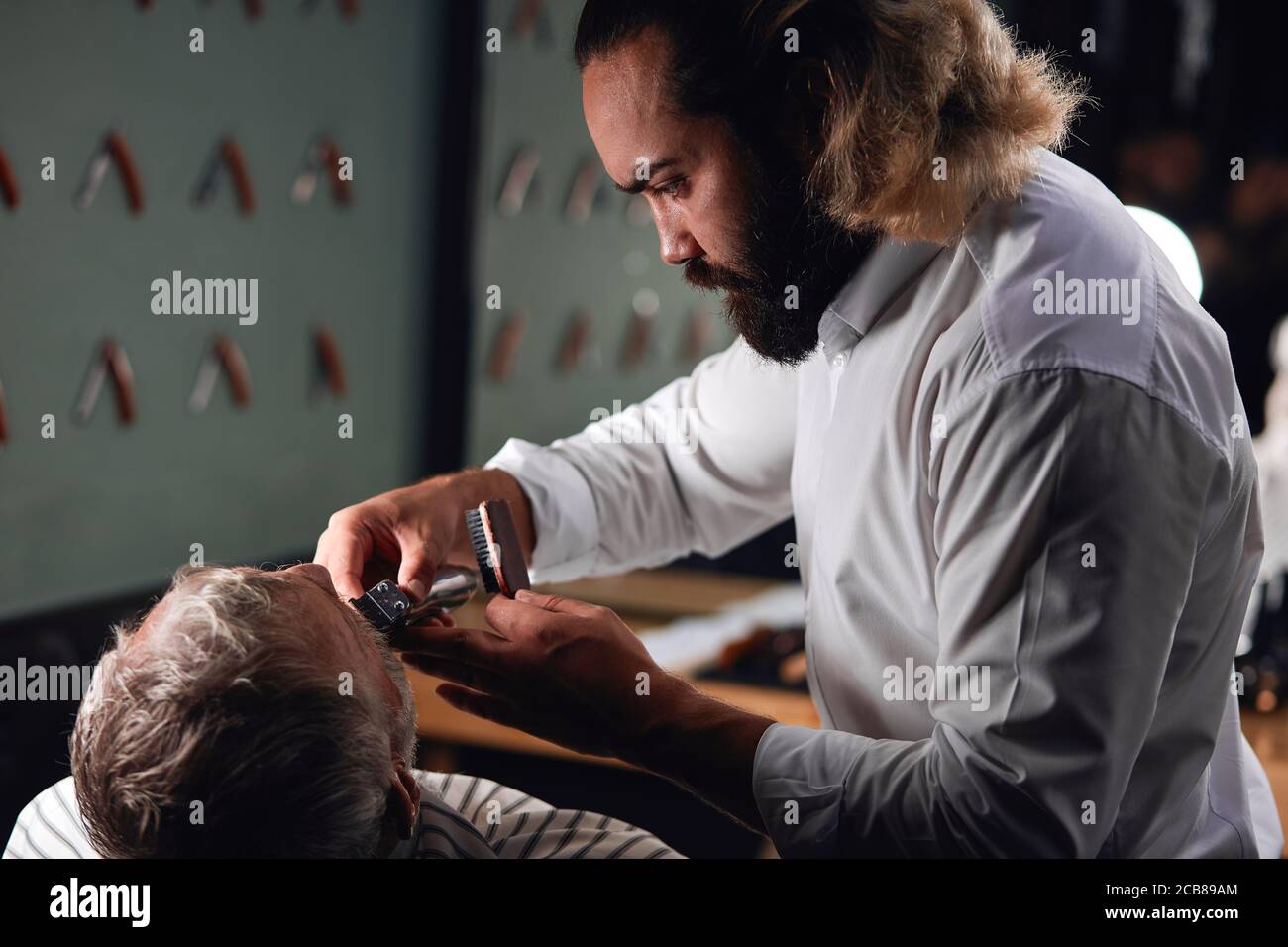 Side view barber making haircut hi-res stock photography and images - Alamy