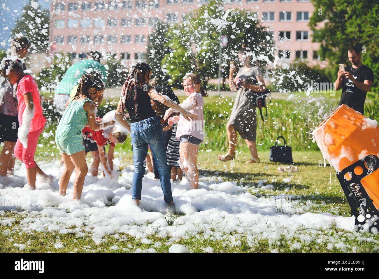 Young people in the foam. A foam party. Group of children having fun ...