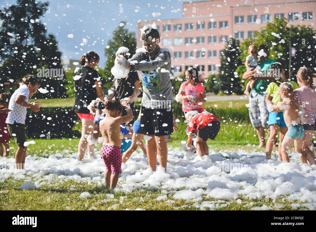Young people in the foam. A foam party. Group of children having fun ...