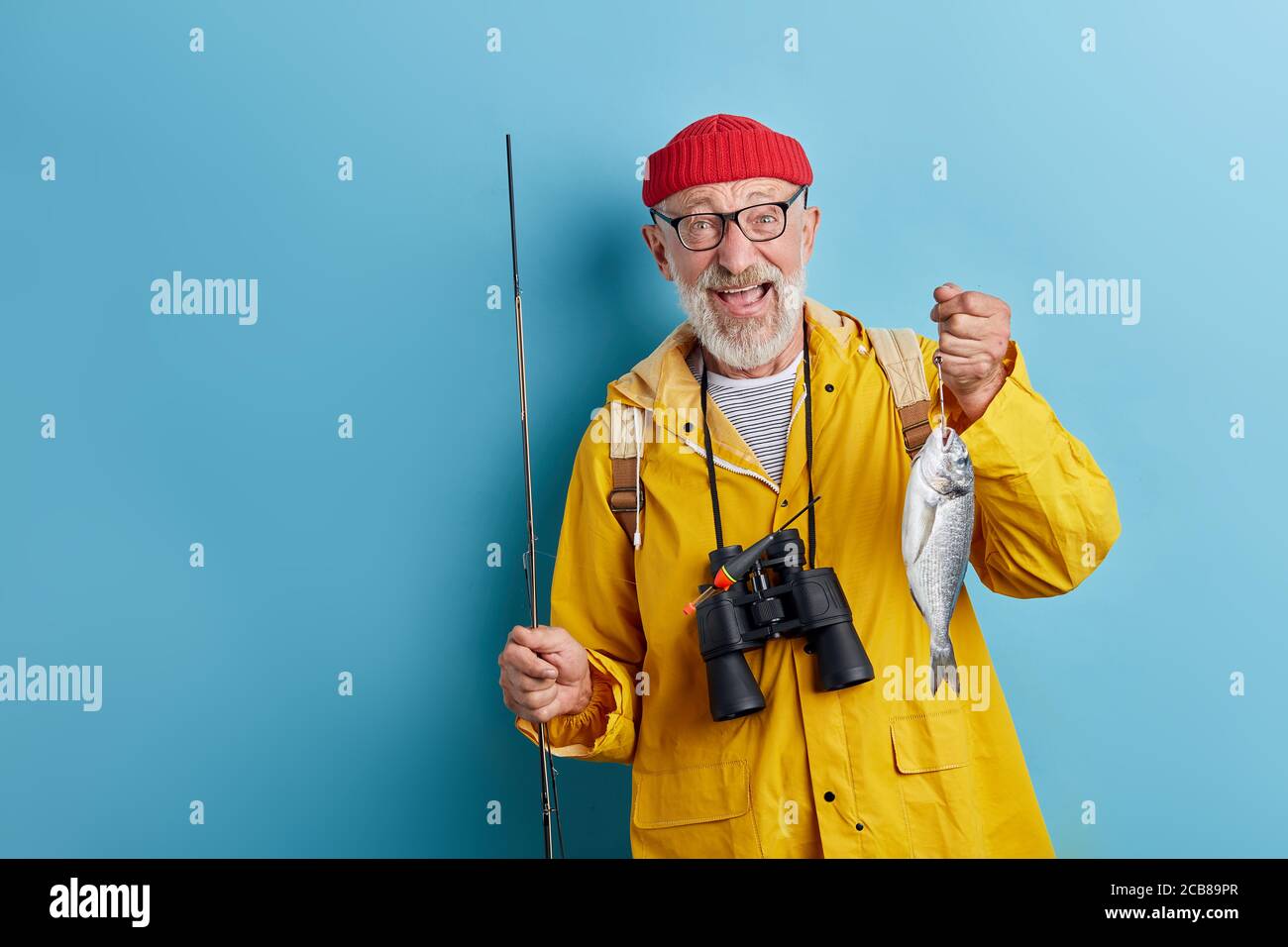 Unshaved happy overjoyed old man wth wide open mouth rejoicing at his ...
