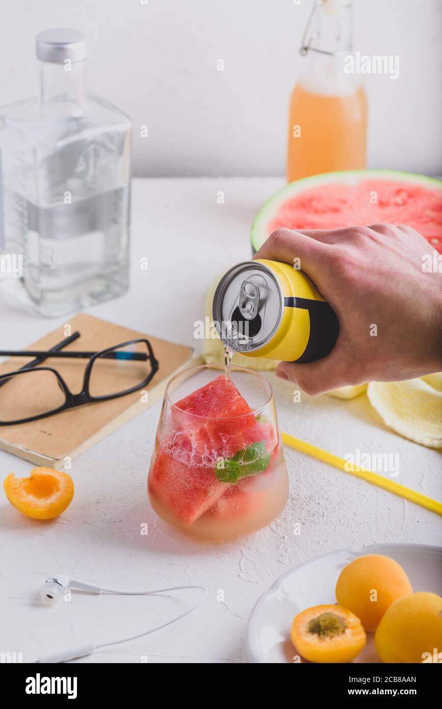 Red cocktail with frozen watermelon cubes, gin and soda Stock Photo - Alamy