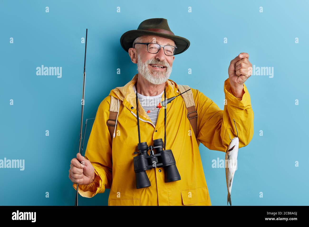 smiling cheerful old fishman boasting about his catch, close up photo ...