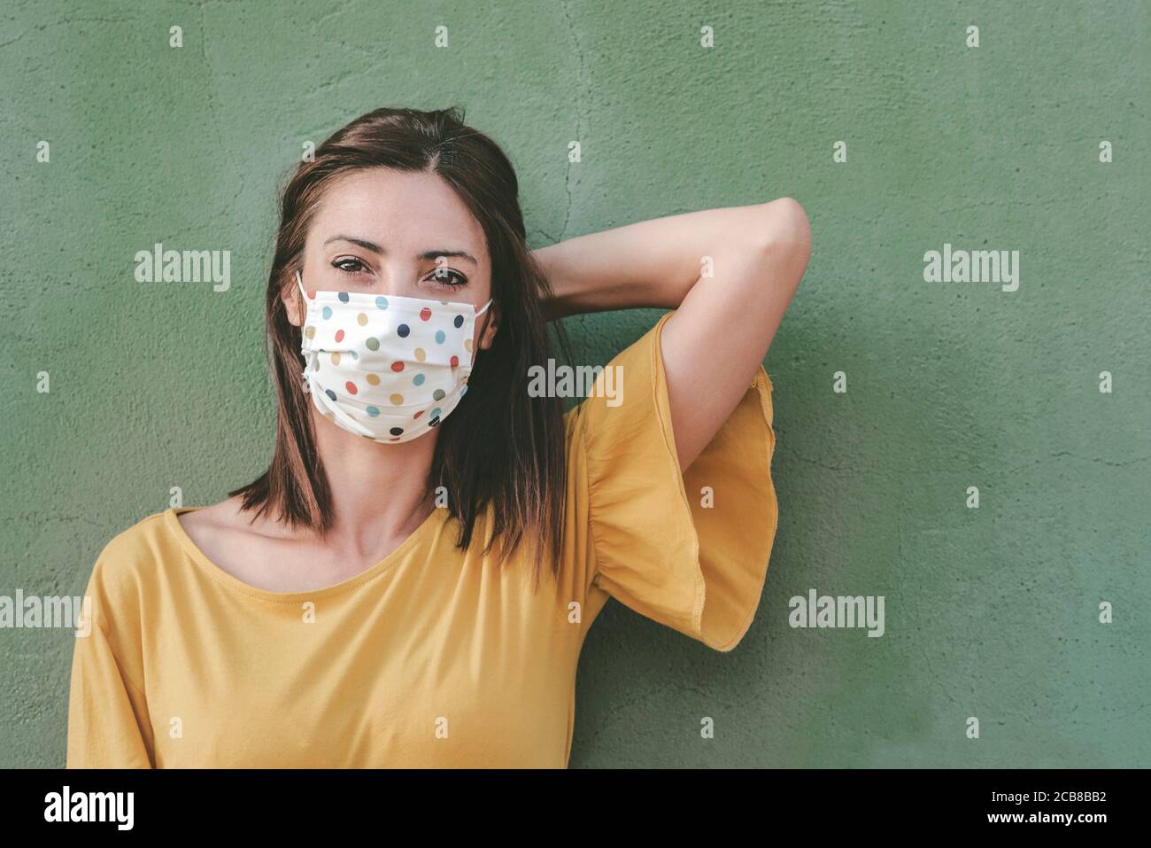 Young woman wearing green mask hi-res stock photography and images - Alamy
