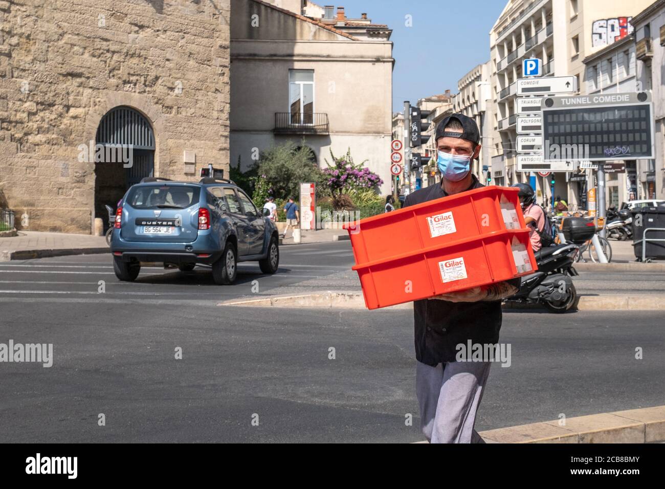 France - Montpellier - 11 August 2020 - Man carrying delivery boxes ...