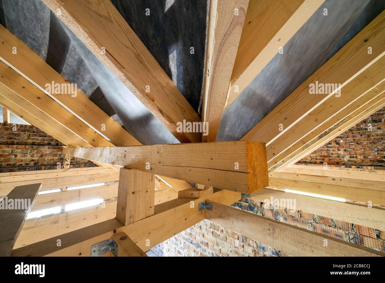 Attic of a building under construction with wooden beams of a roof ...