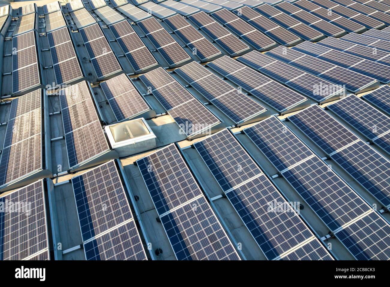 Aerial view of many photo voltaic solar panels mounted of industrial ...
