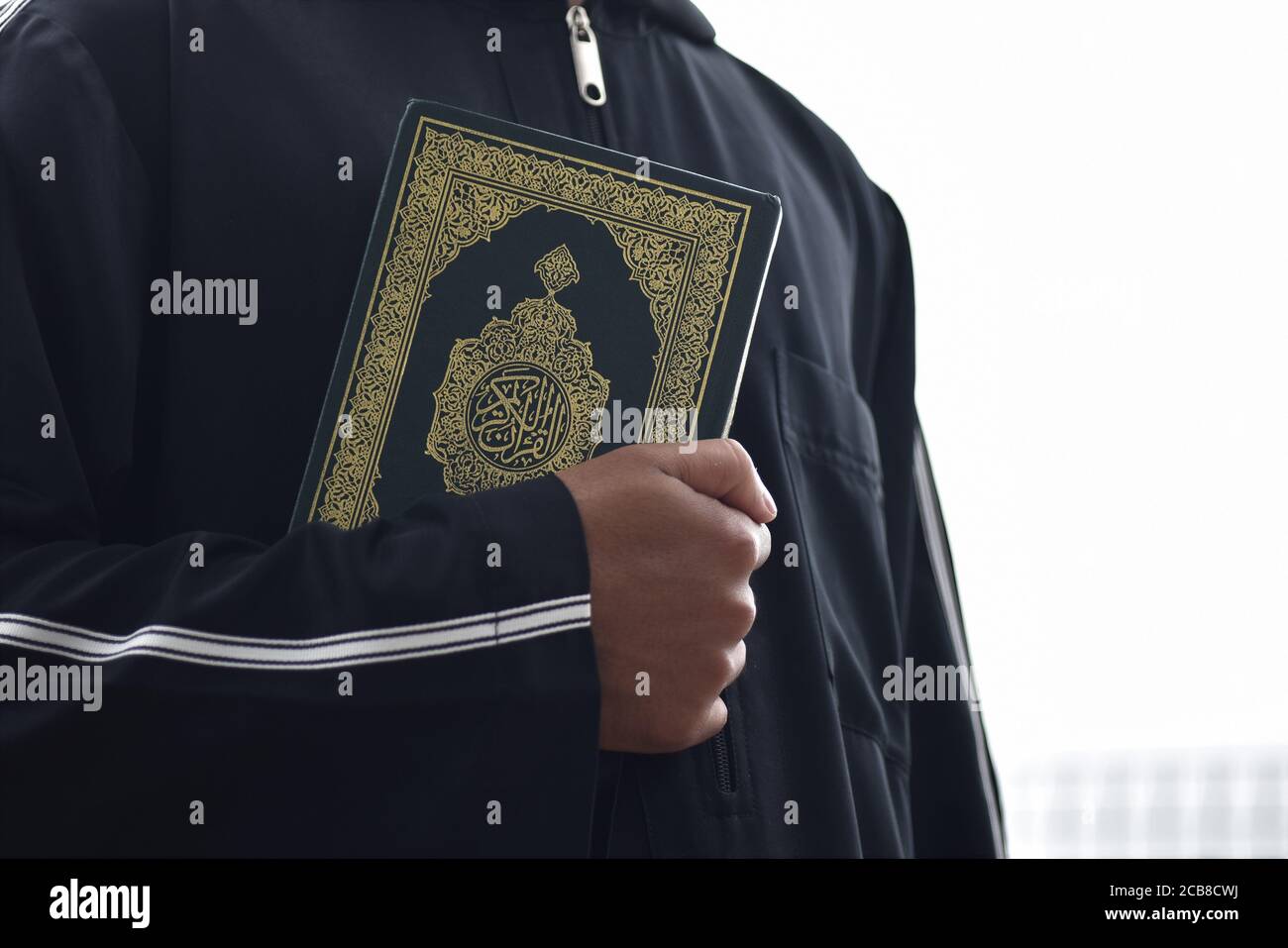 Holy Quran in hand with arabic calligraphy meaning of Al Quran Stock ...