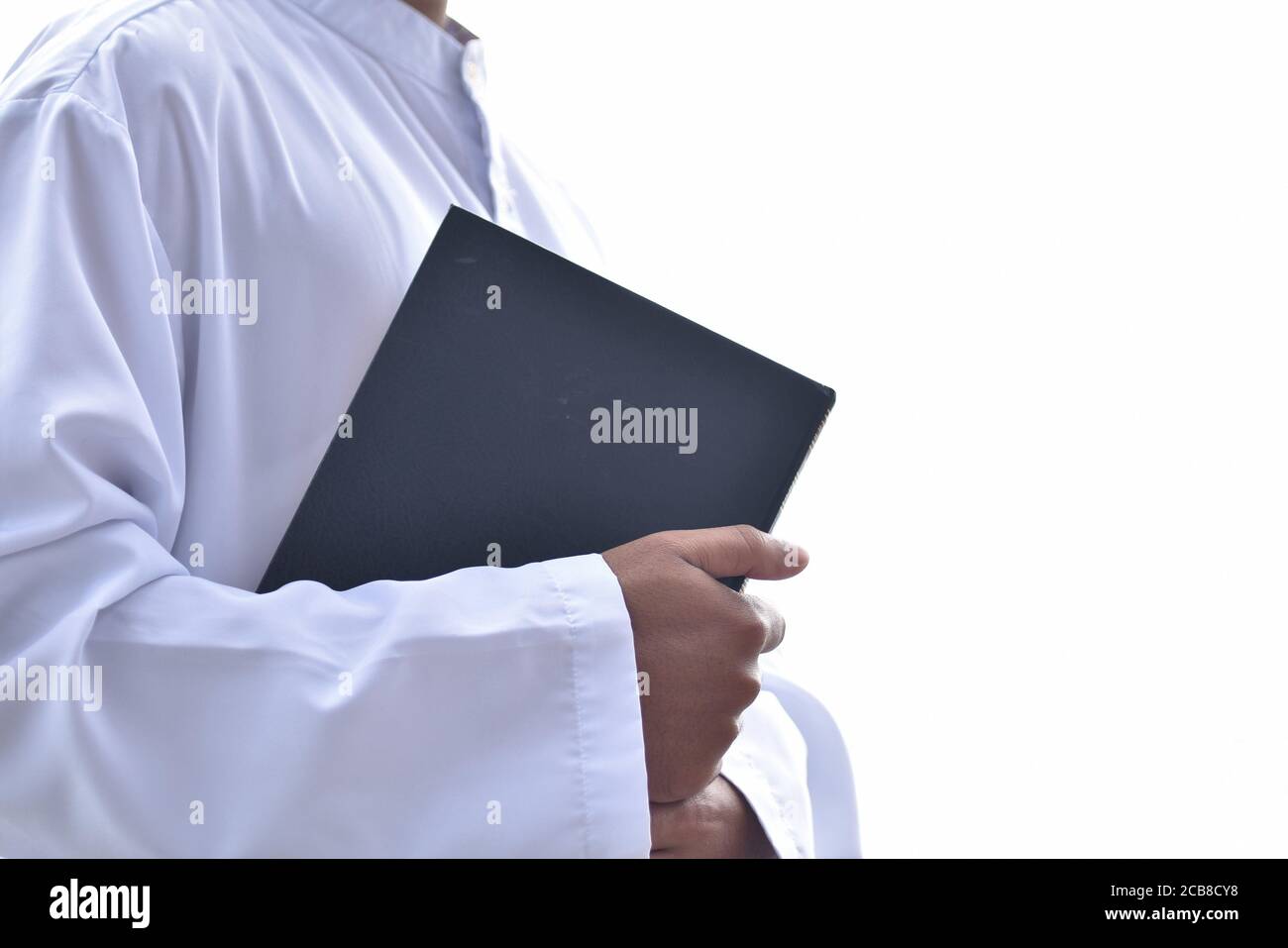 Holy Quran in hand with arabic calligraphy meaning of Al Quran Stock ...